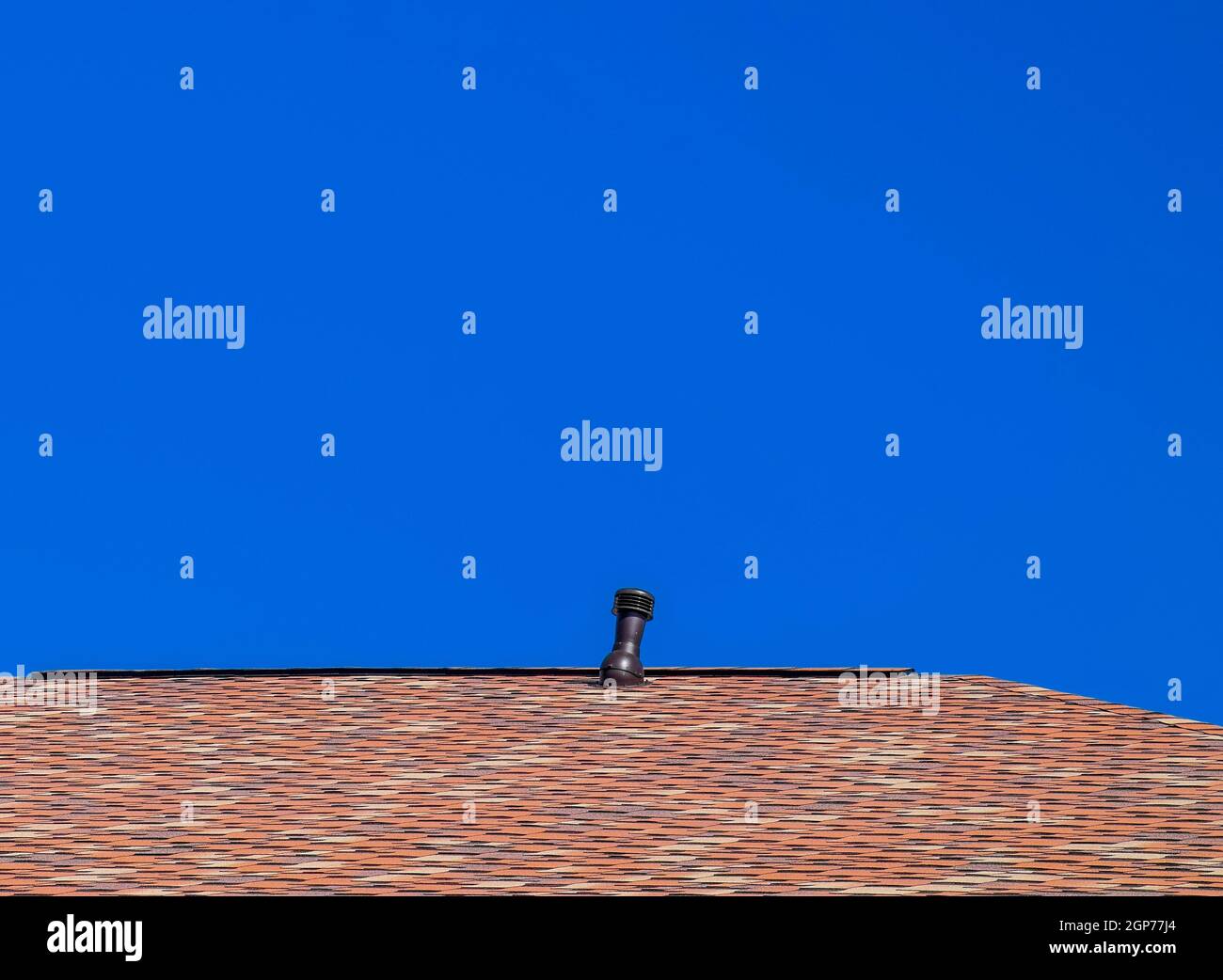 Ventilation on the roof. Roof from multi-colored bituminous shingles ...