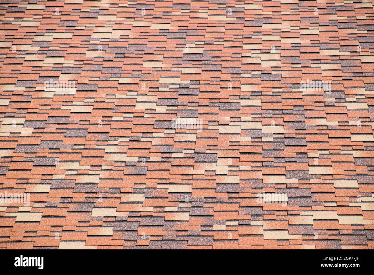 Roof from multi-colored bituminous shingles. Patterned bitumen shingles ...