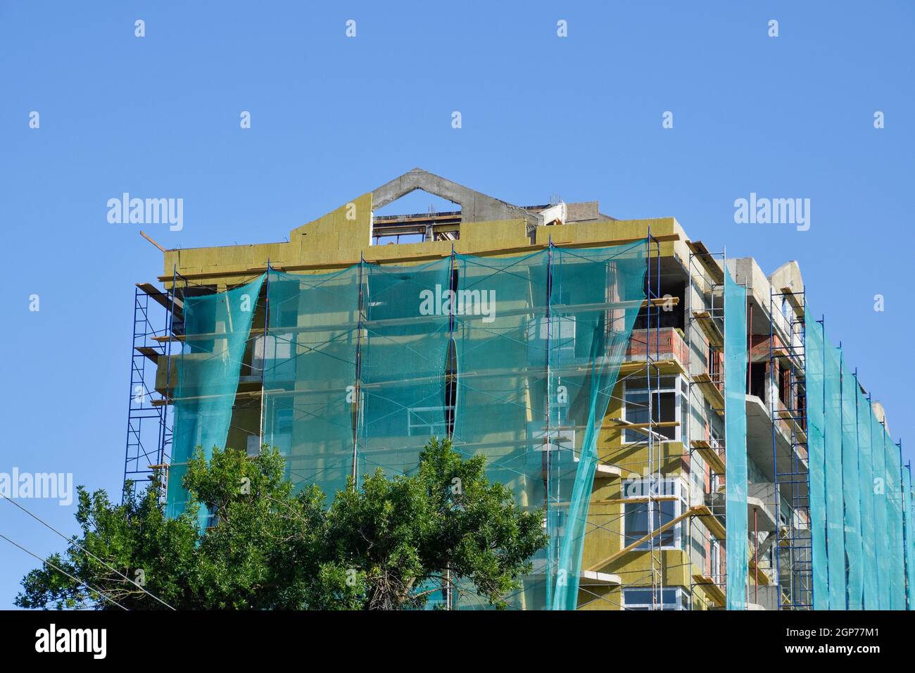 Safety net in the newly built high-rise building. Green grid on ...