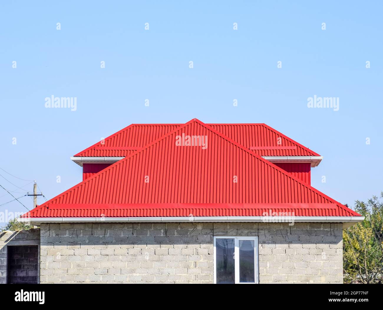 Red corrugated roof. House of cinder block. The house with plastic ...