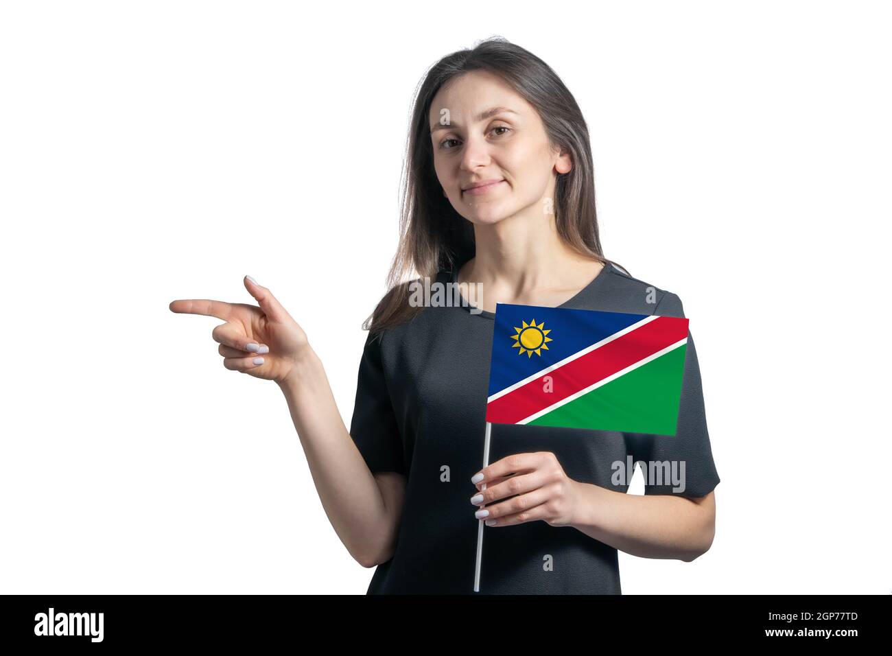 Happy young white woman holding flag Namibia and points to the left ...