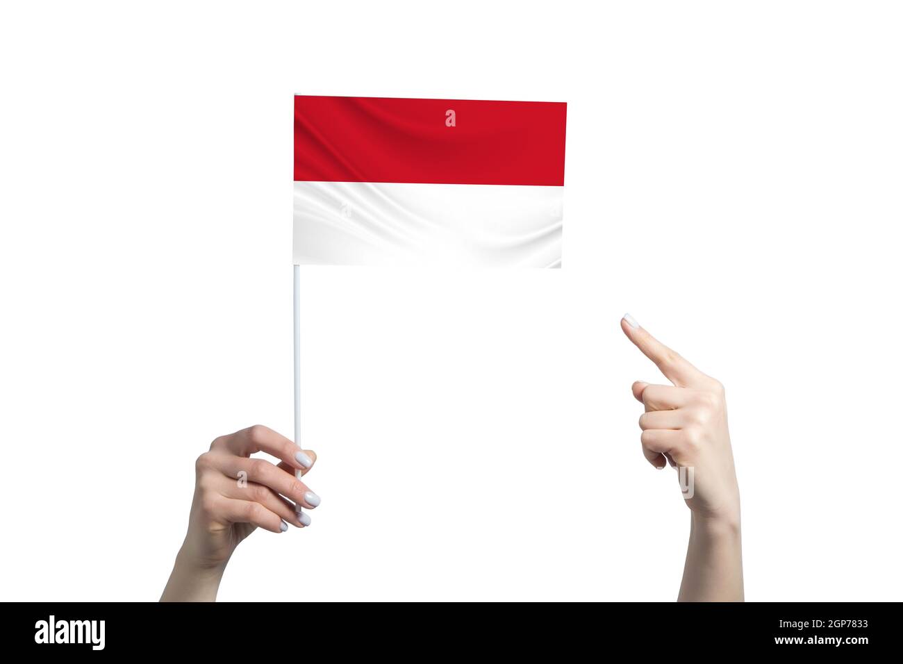 A beautiful female hand holds a Monaco flag to which she shows the ...