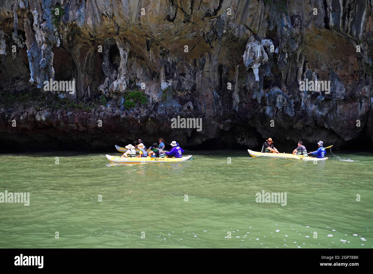 Tourists with canoe, eroded limestone rocks, Phang Nga bay, Thailand ...