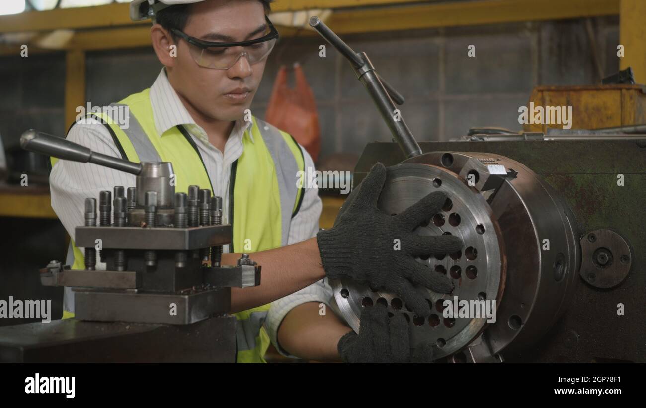 Asian professional mechanical operation man wearing uniform hardhat and ...