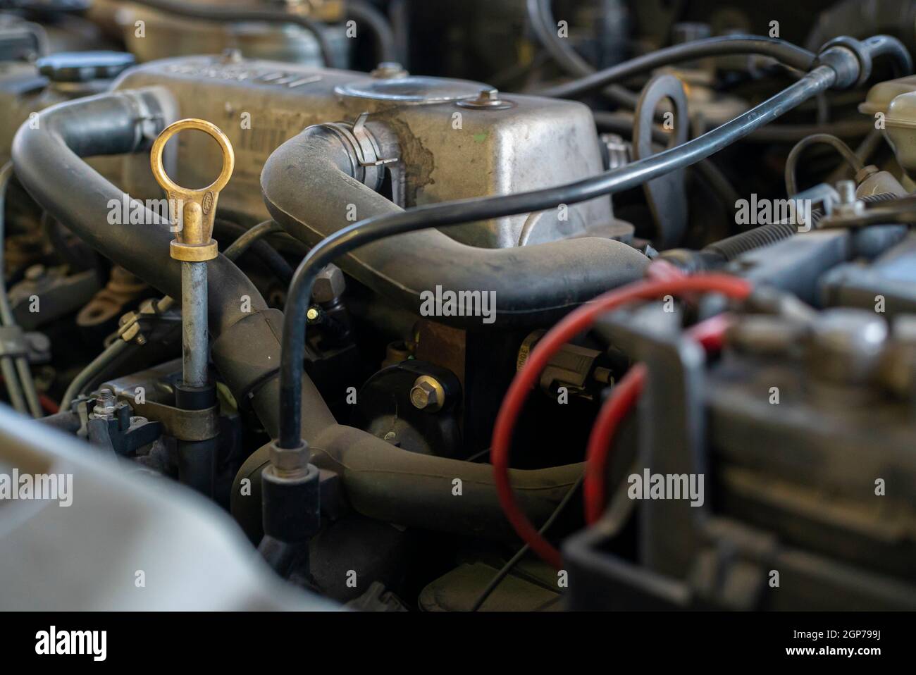 Detail of a used engine with mechanical parts on view inside a car ...