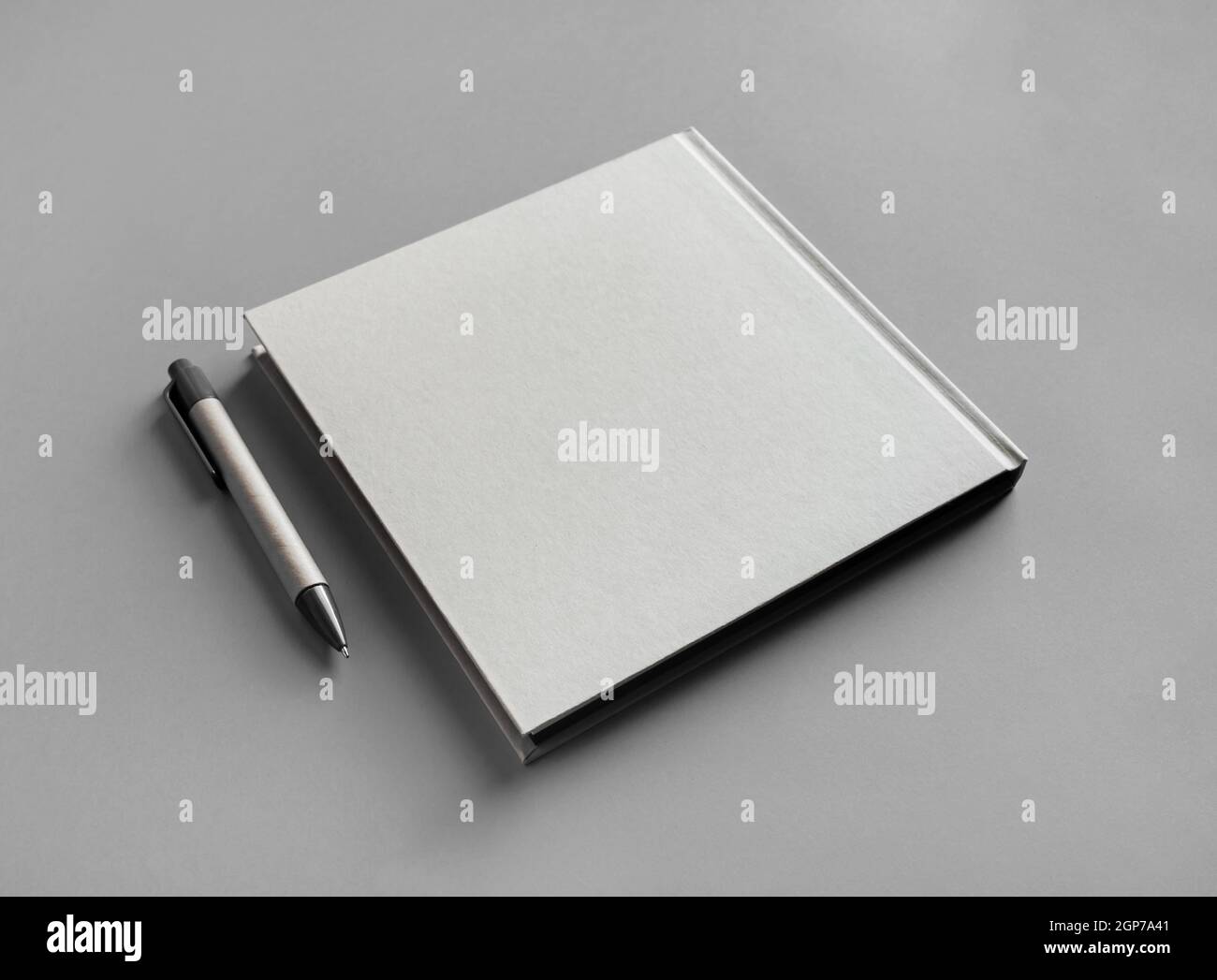 Closed blank square brochure and pen on gray paper background Stock ...