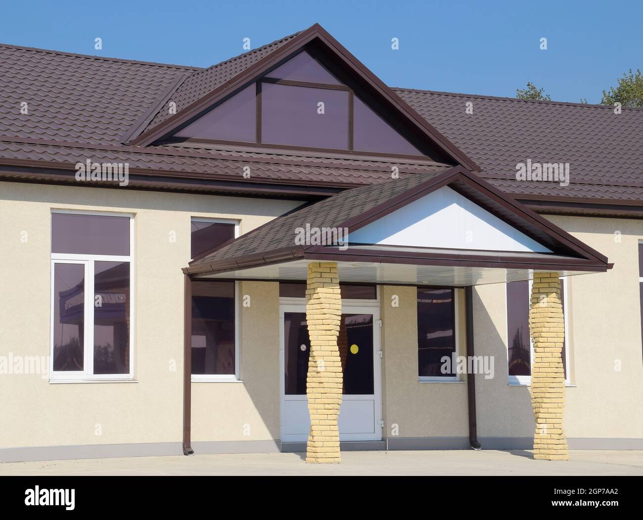 building with a brown roof. The main entrance to the house. Modern ...
