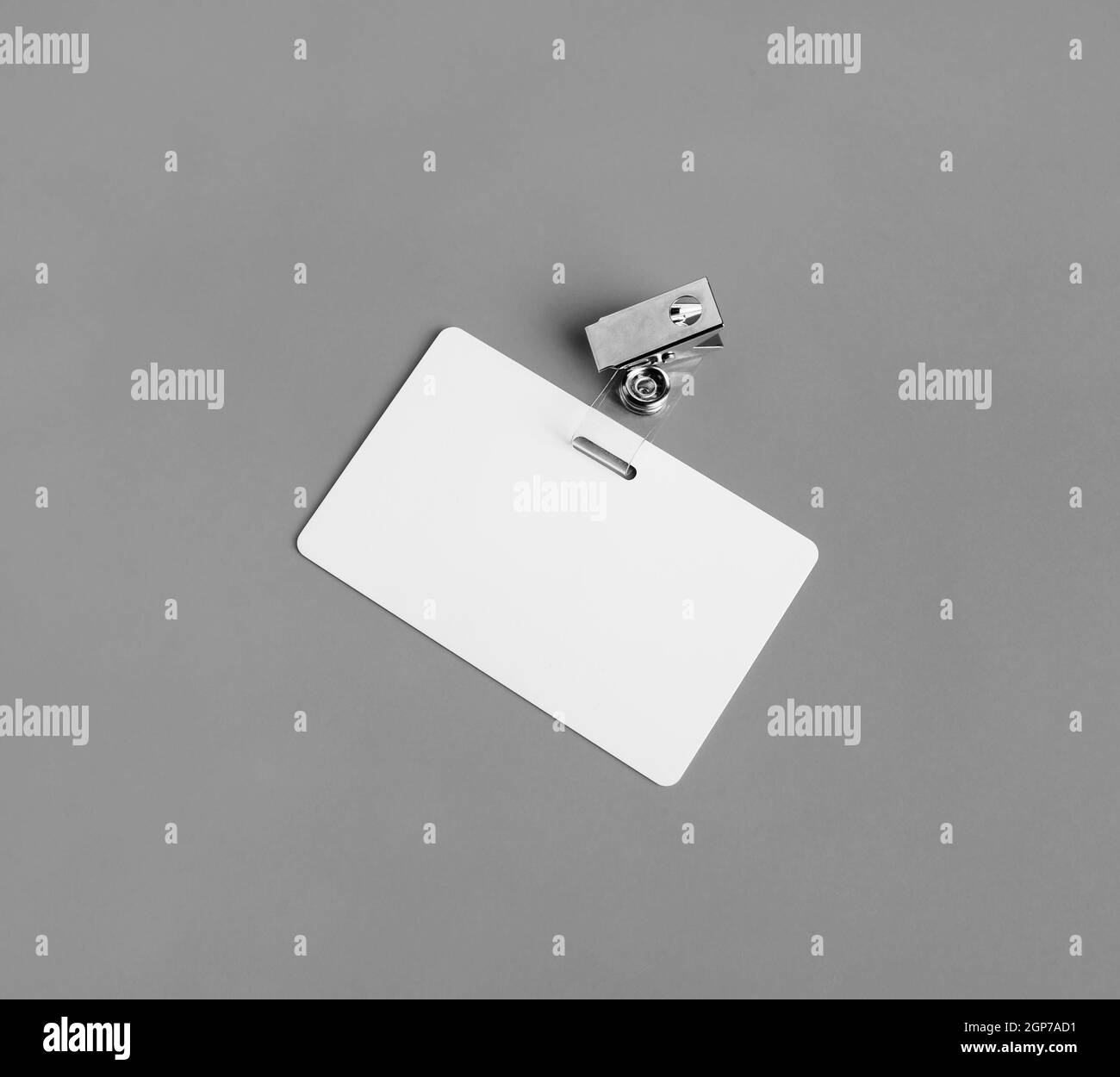 Blank badge on gray paper background. Blank plastic id card. White ...