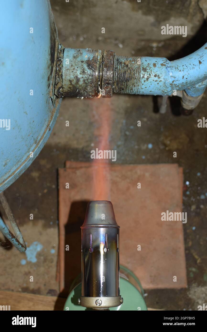 Heating a steel pipe with a blowtorch. The flame of a blowtorch Stock ...