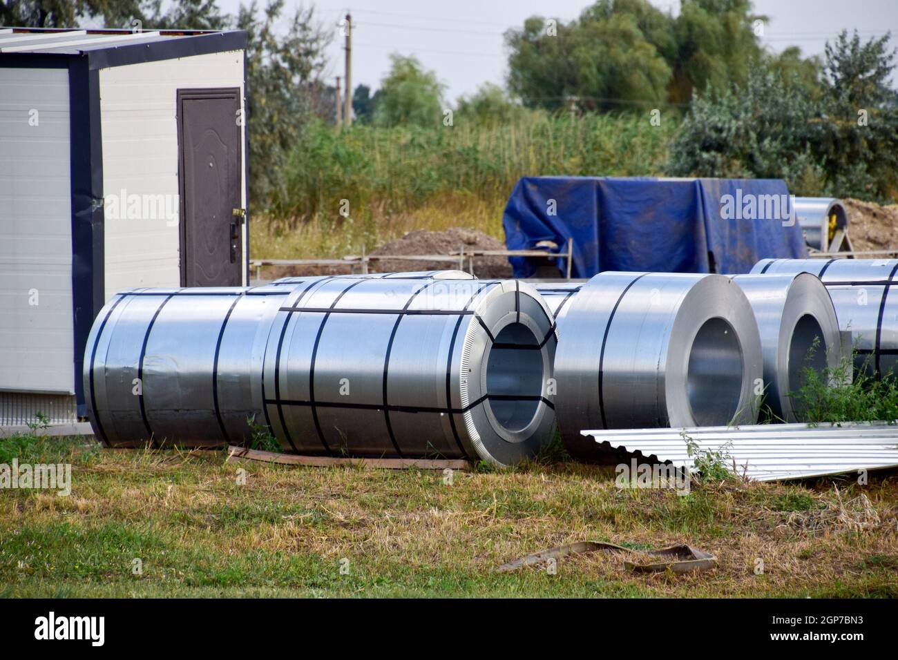 Rolls of sheet metal. Storage of building materials Stock Photo - Alamy