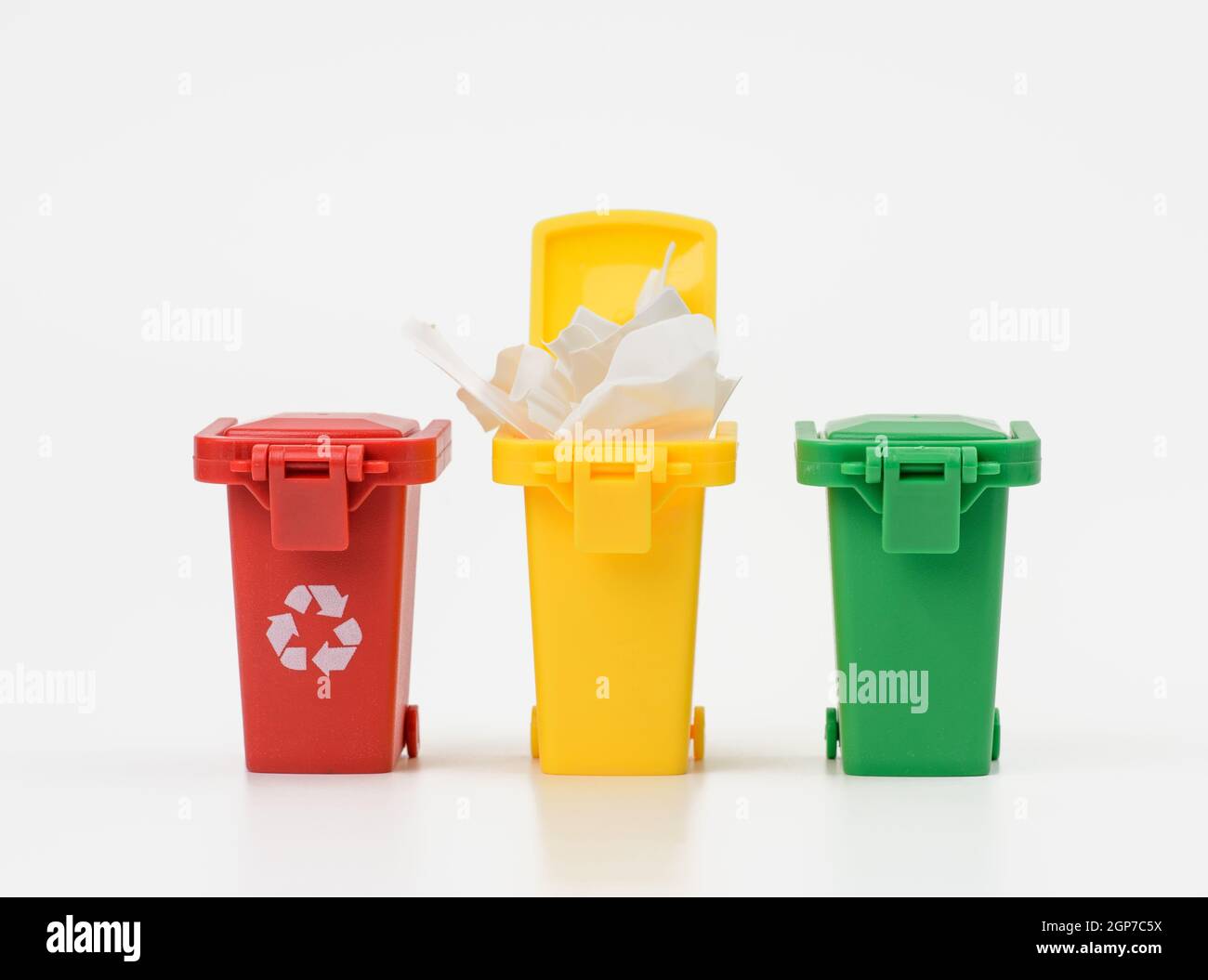 three multi-colored plastic containers on a white background, the ...