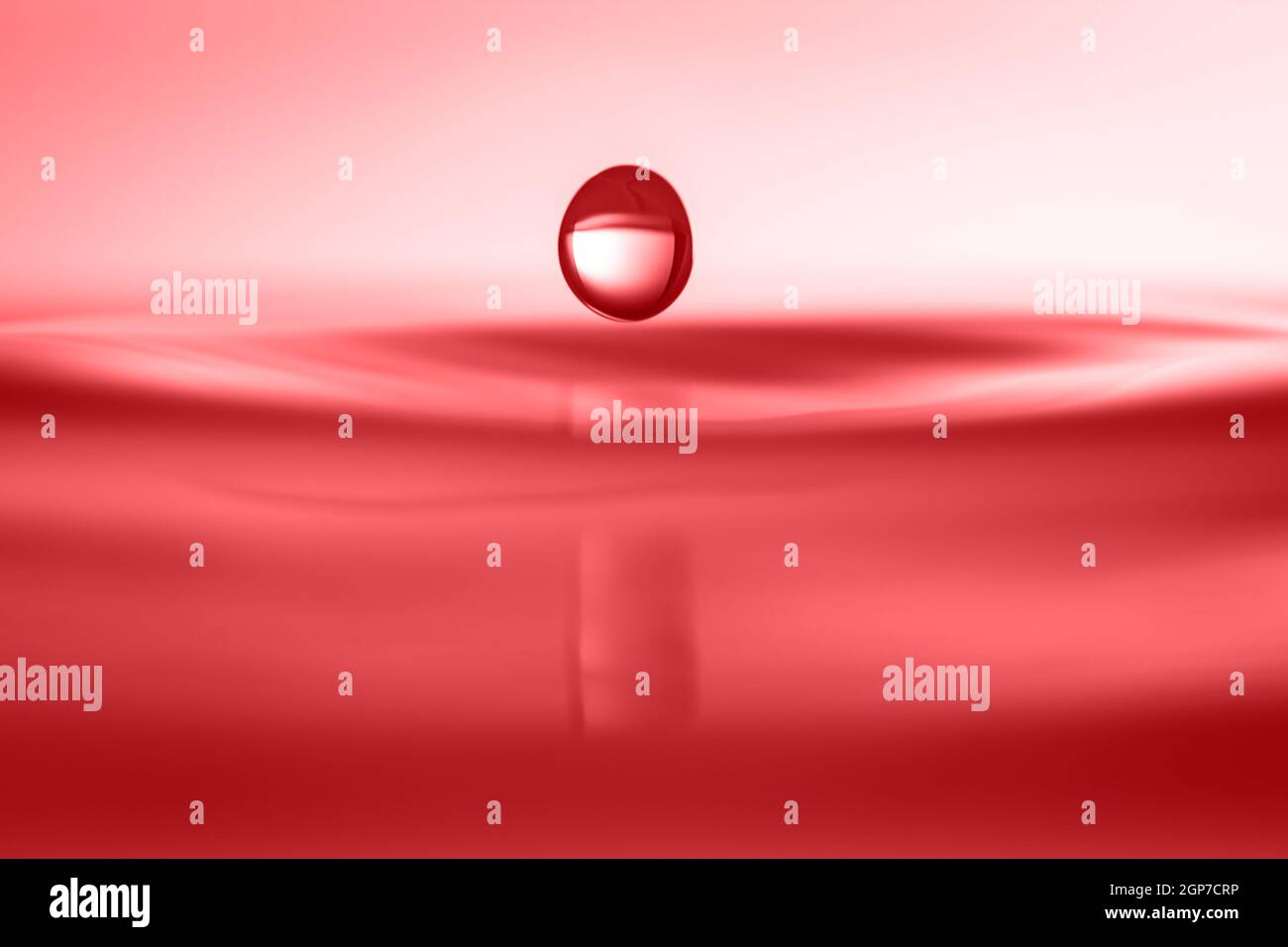 A water drop falling down onto a water surface Stock Photo - Alamy