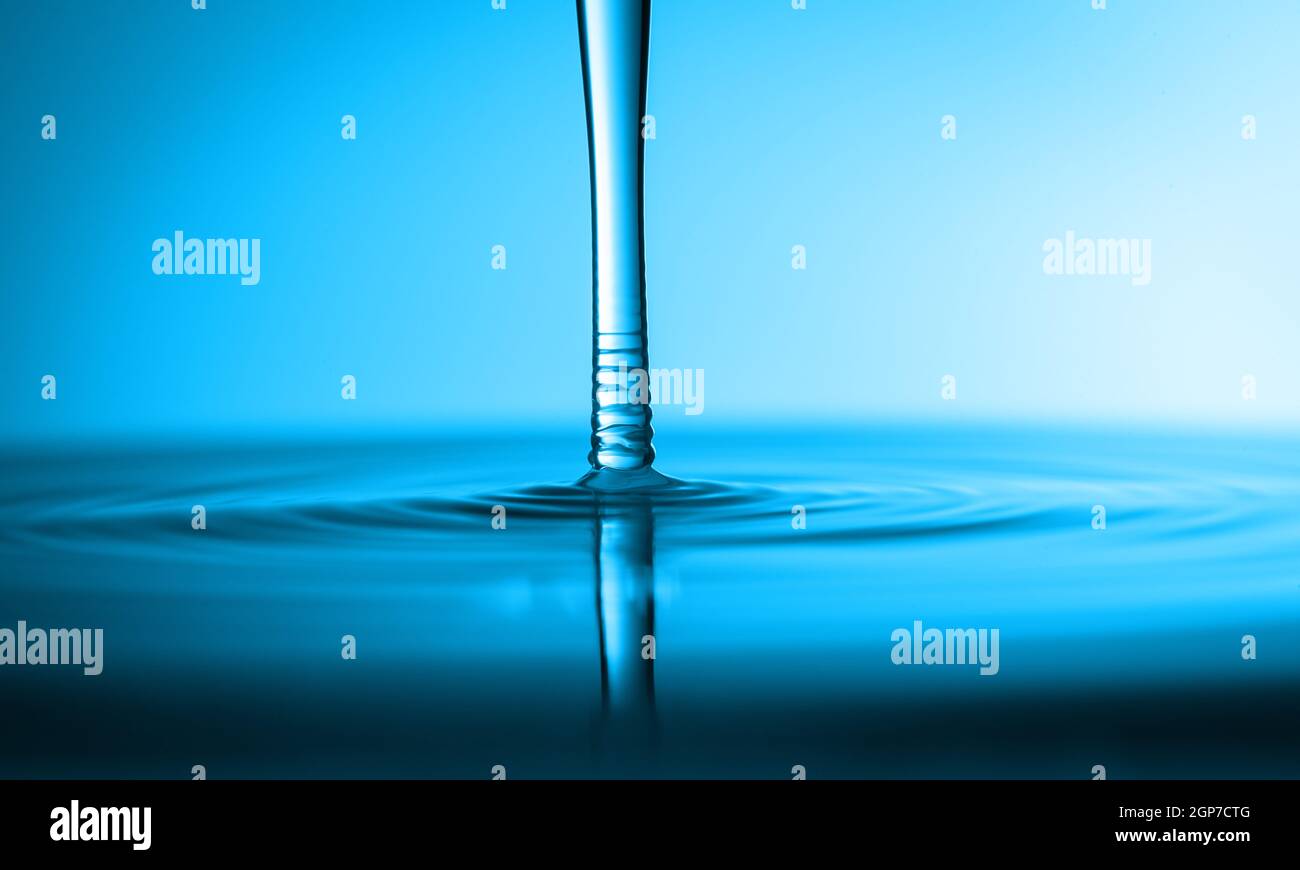 Water falling down onto a water surface Stock Photo - Alamy