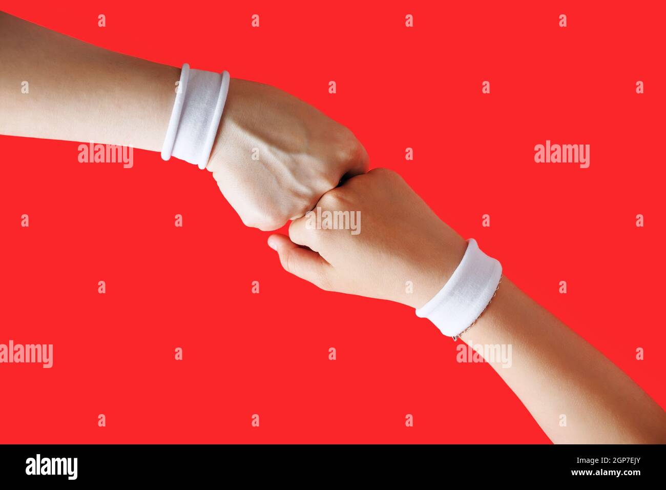 Hands clenched into fists. Fight concept. Two female fists hitting each ...