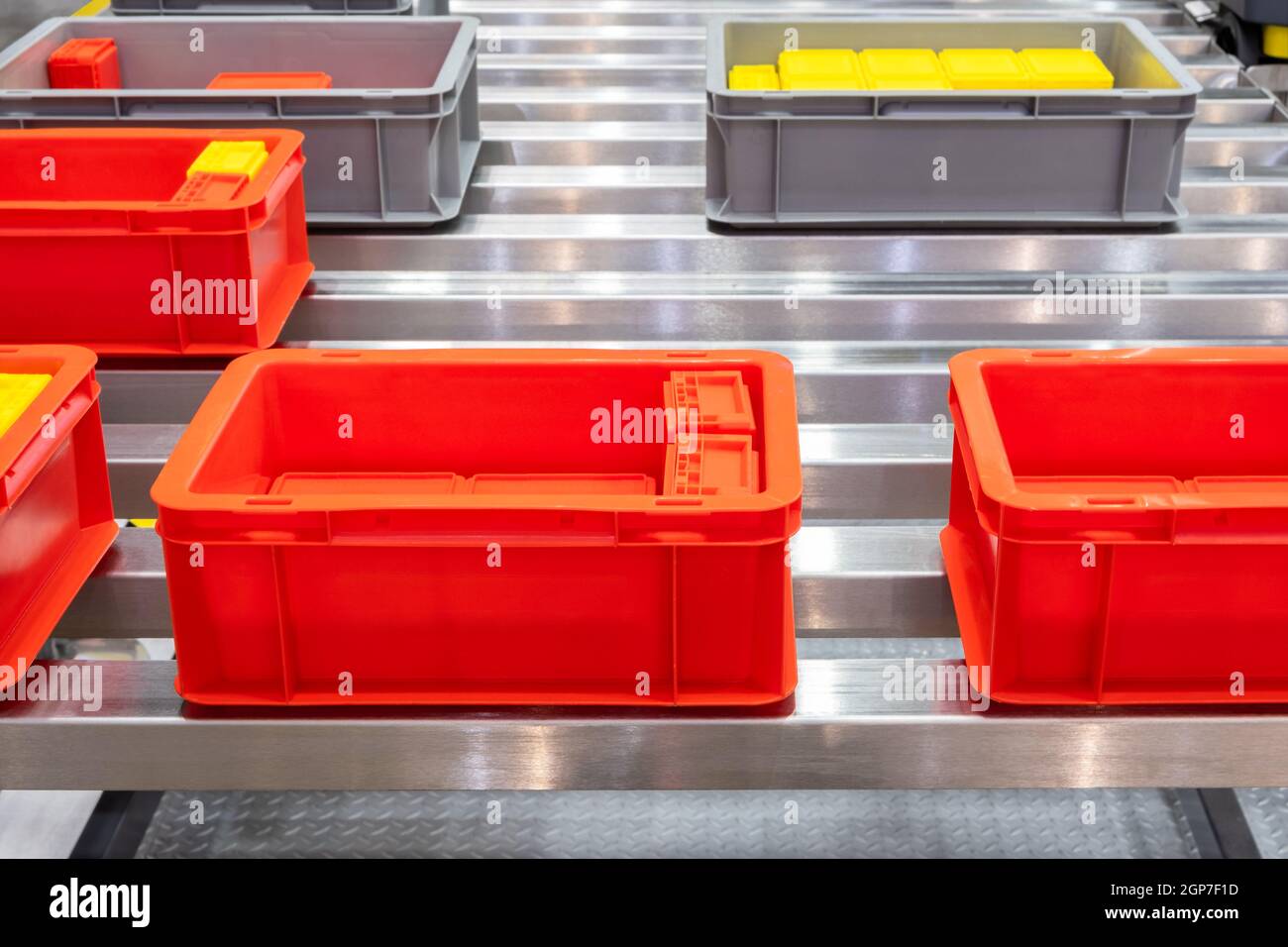 Plastic red box on roller line for tranfer production part in prodine ...