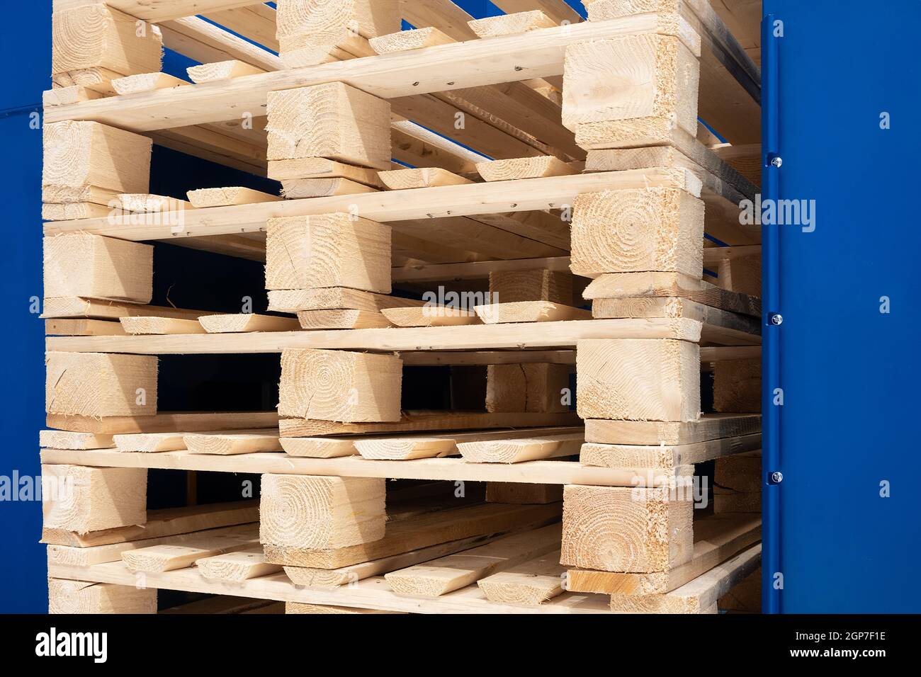 A lot stacks of used wooden pallets of euro type on warehouse is ready ...