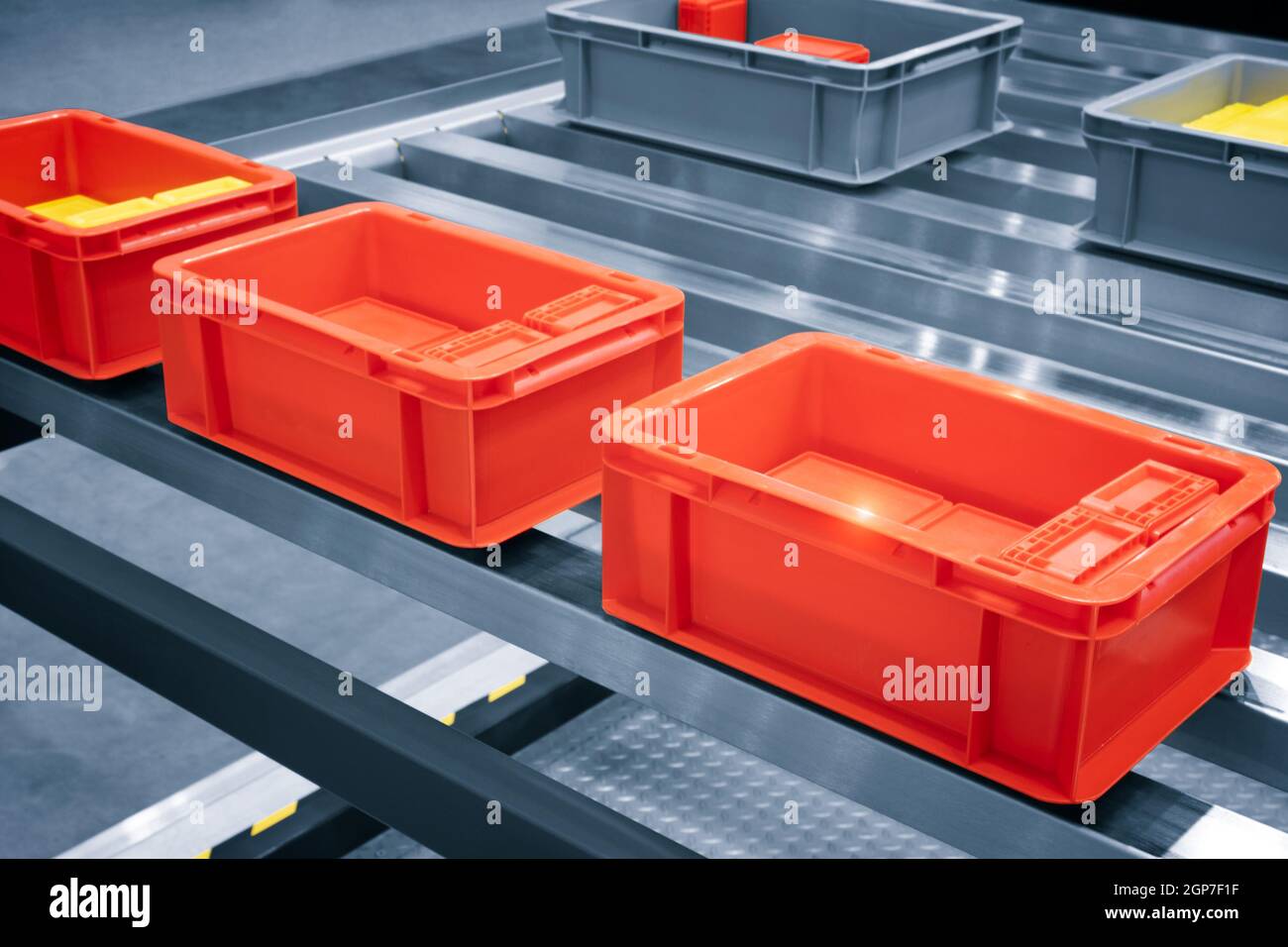 Plastic red box on roller line for tranfer production part in prodine ...