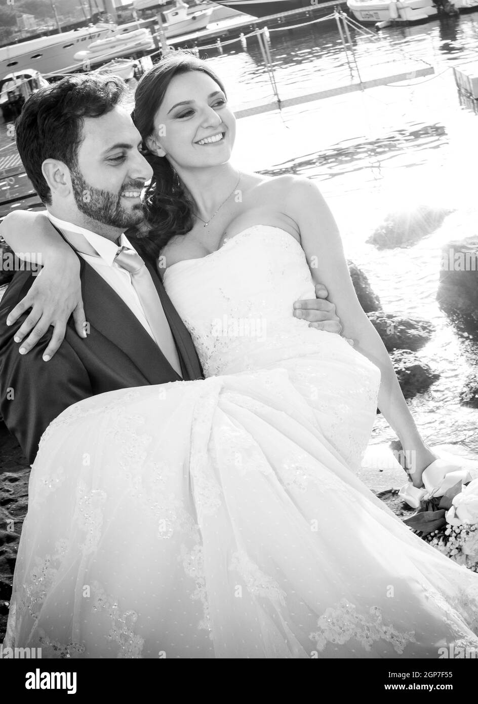 Married couple in day of their wedding. Bride in the arms of her ...