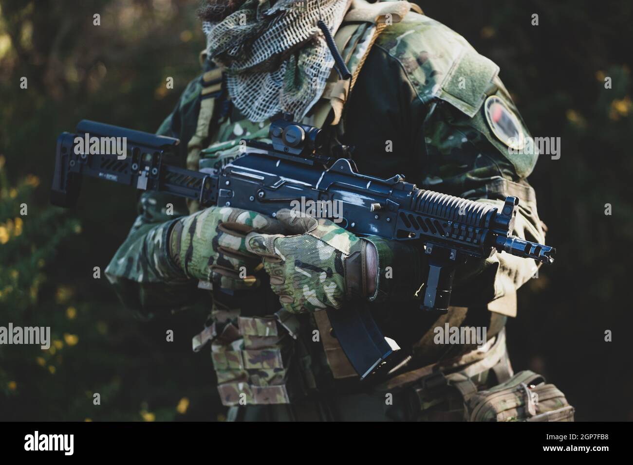 Airsoft military game player in camouflage uniform with armed assault ...