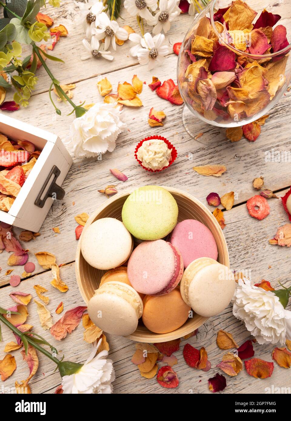 Still life of macaroon cakes in bowl on wooden background Stock Photo ...