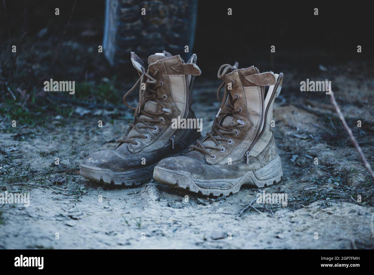 Old brown military boots on mud and grass Stock Photo - Alamy