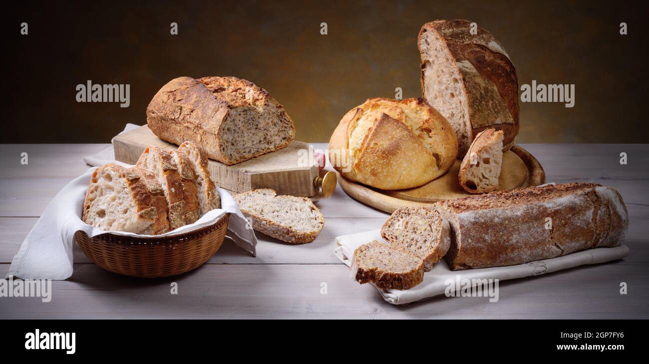 Different types of traditional bread on wooden table, space for text ...