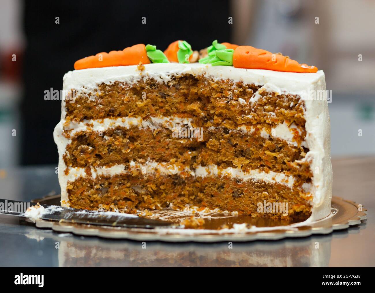 Carrot cake with cream cheese frosting and little carrots on top Stock ...