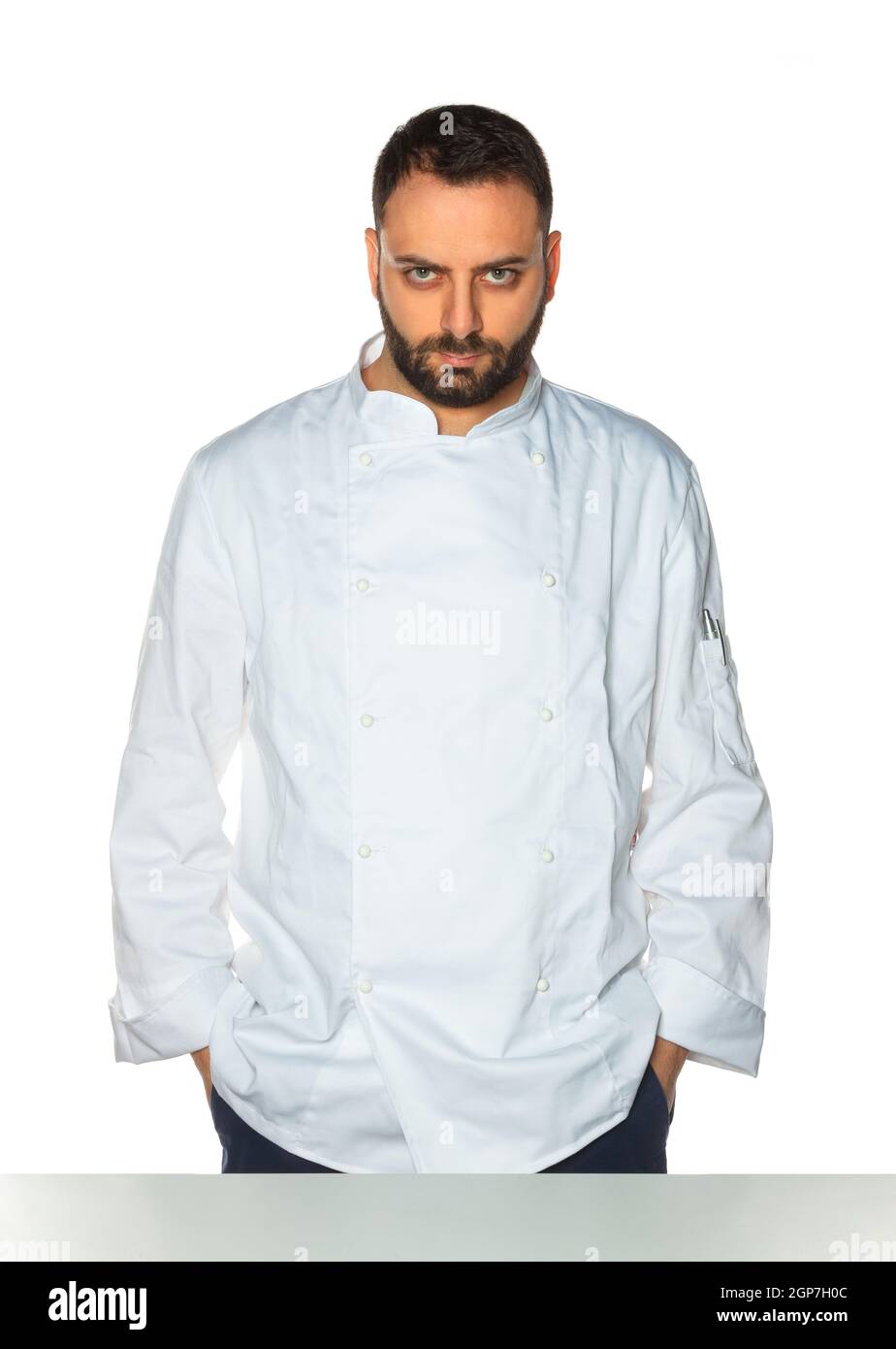 Serious chef in white uniform isolated on white background Stock Photo ...