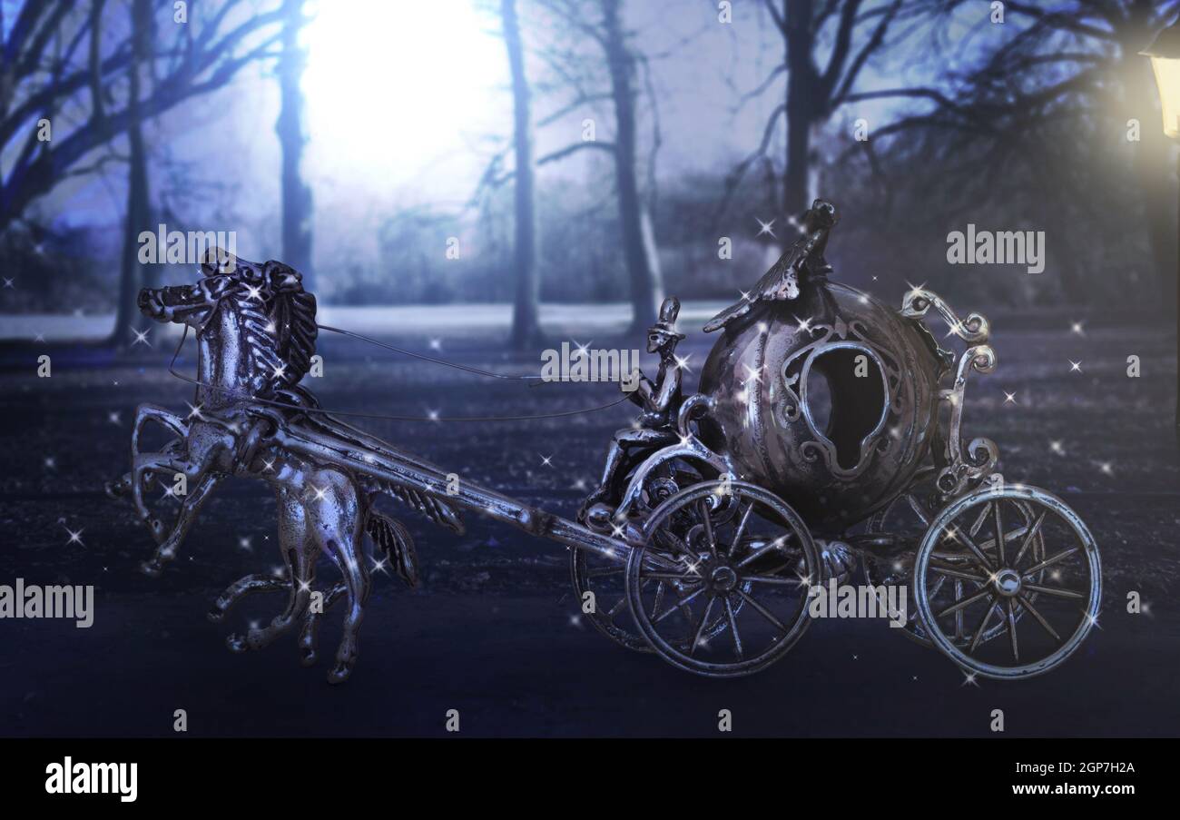 Magical carriage pulled by horses in a park at night in the moonlight ...