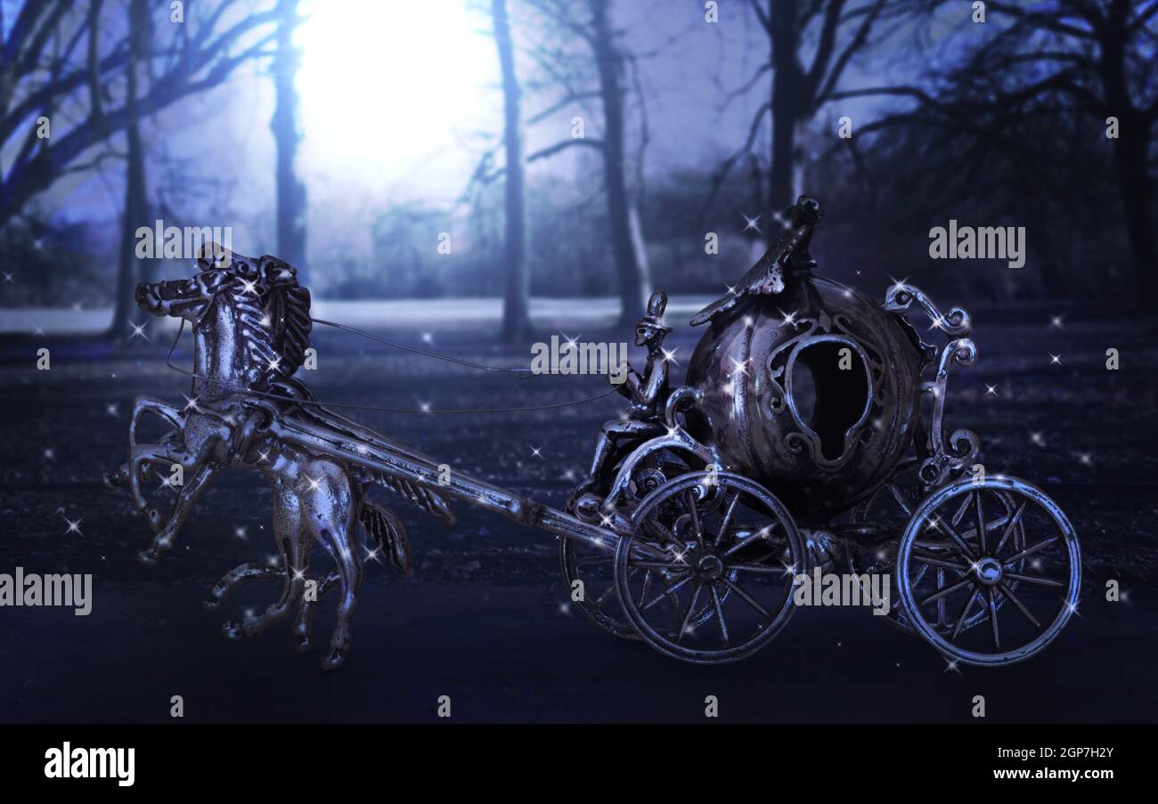 Magical carriage pulled by horses in a park at night in the moonlight ...