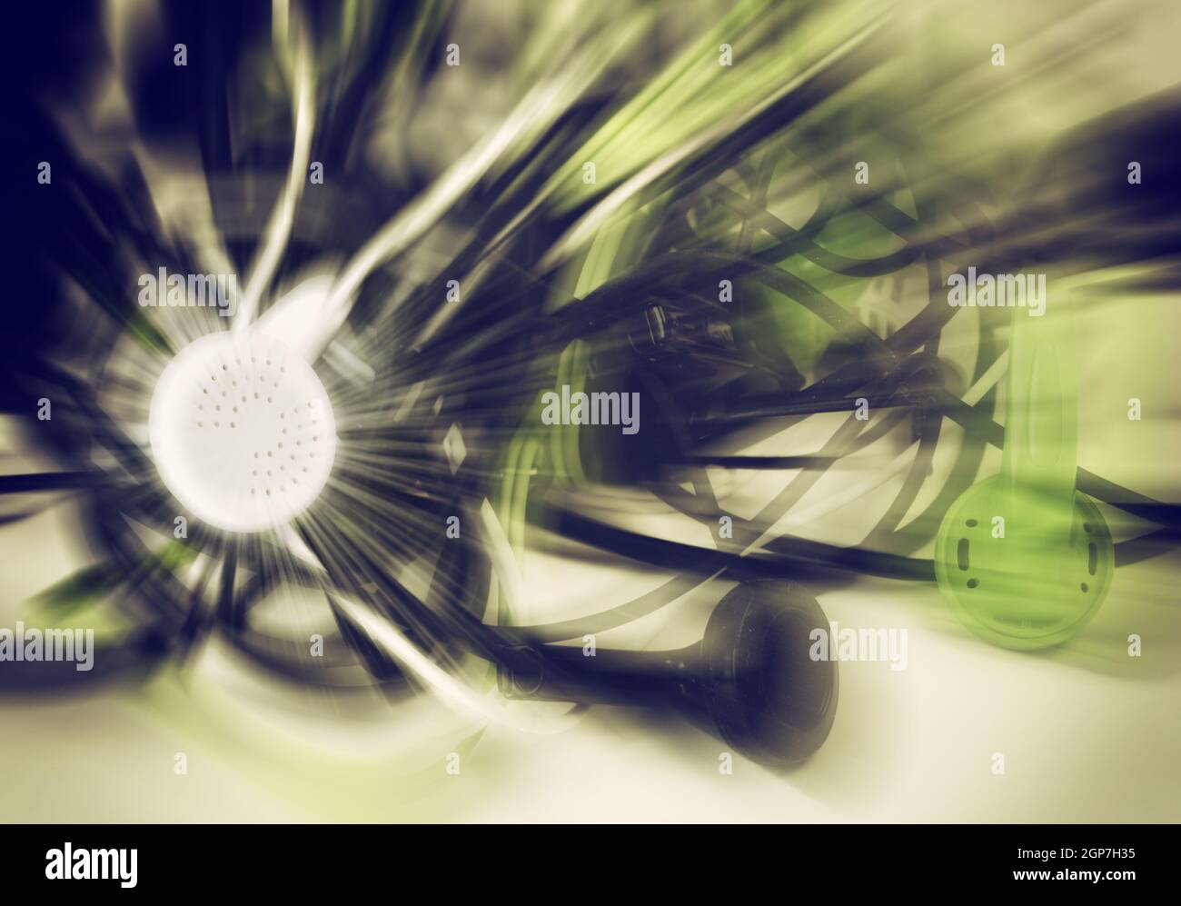 Twisted headphones, of different colors, on white background Stock Photo - Alamy