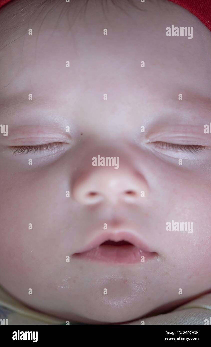 newborn baby girl sleeping in bed at home Stock Photo - Alamy