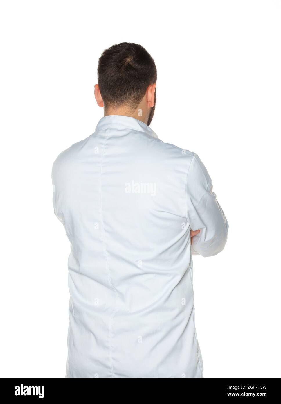 Young chef from behind in white uniform isolated on white background ...