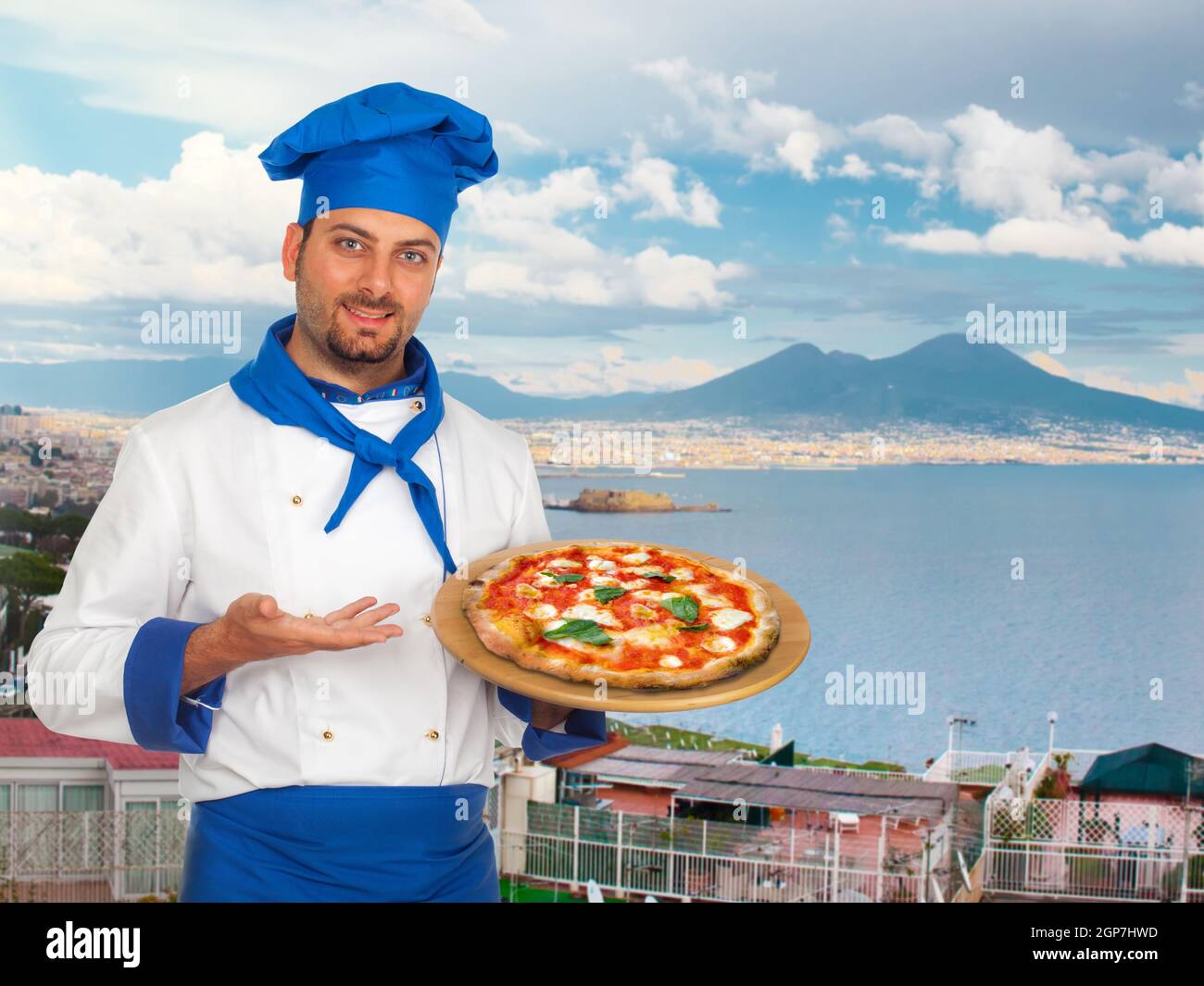 Young chef with neapolitan pizza margherita with Gulf of Naples in ...