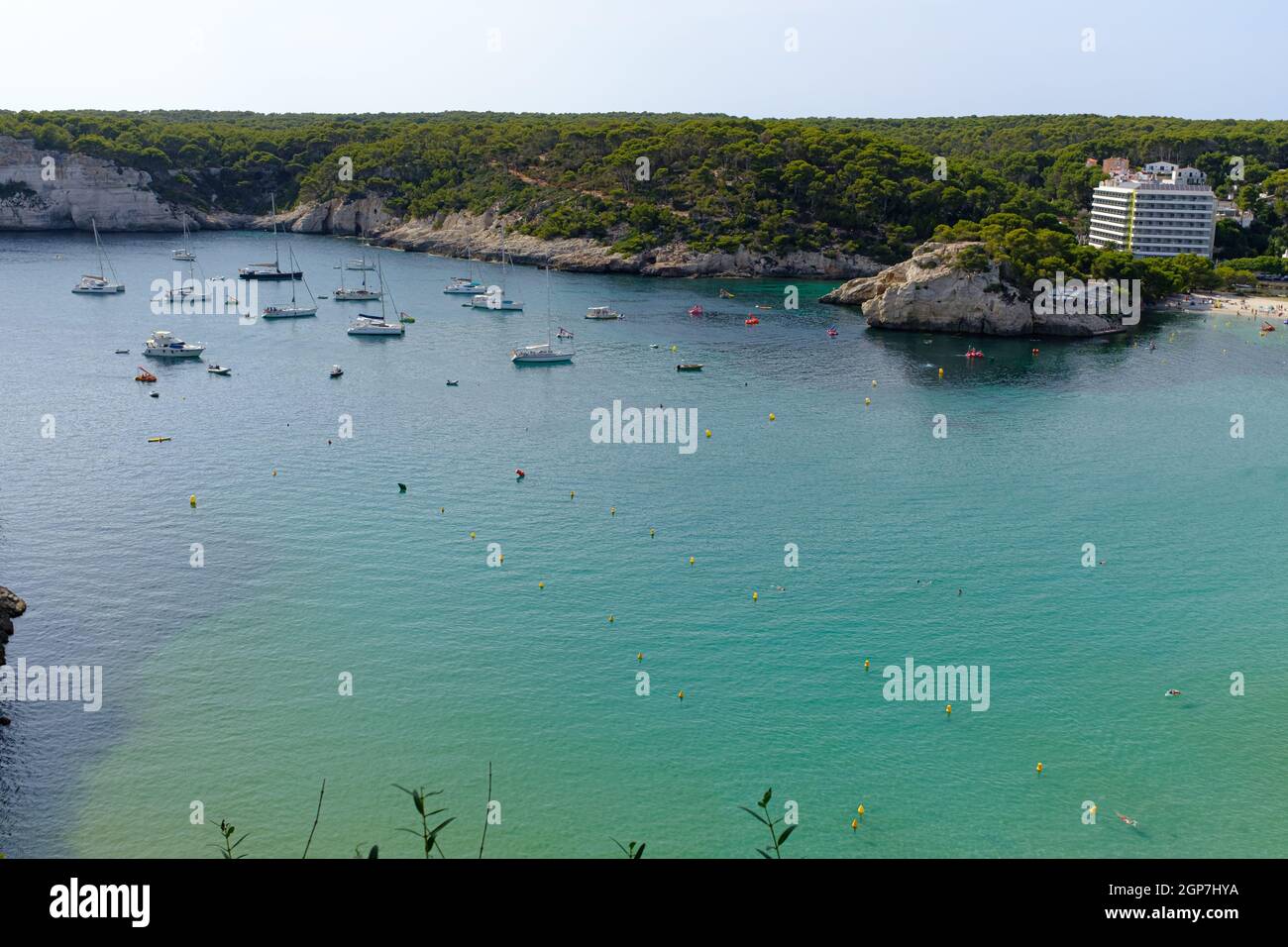 Some boats parked on a beautiful blue beach landscape in Menorca Stock ...