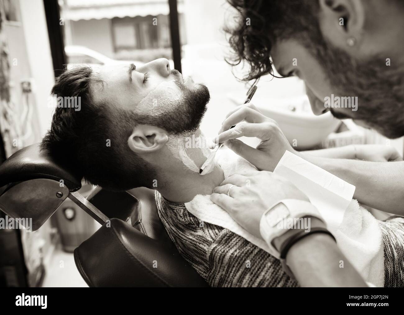 Traditional ritual of shaving the beard in a old style barber shop ...