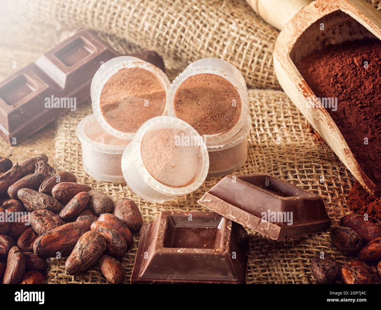Capsules of chocolate with cocoa powder, cocoa beans and pieces of ...