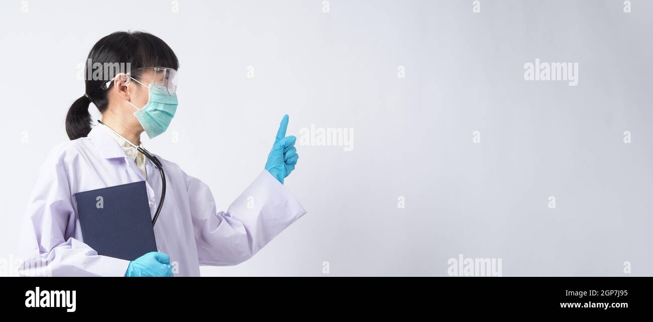 Doctor in uniform points to an empty area. Wearing blue medical latex ...