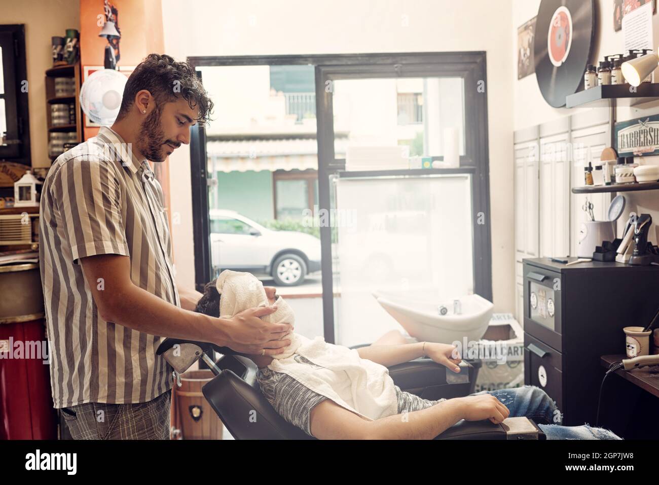 Traditional ritual of shaving the beard in a old style barber shop ...