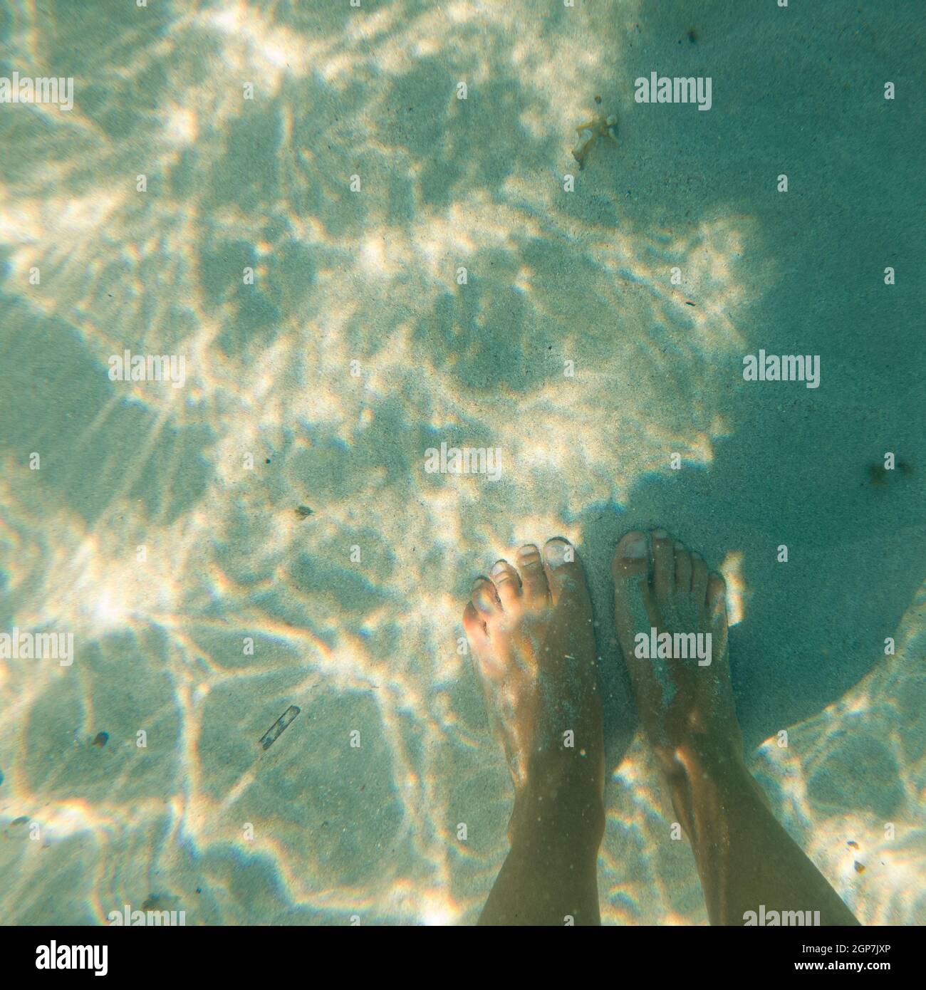 White feet relaxing his toes on the white sand of a beach Stock Photo ...