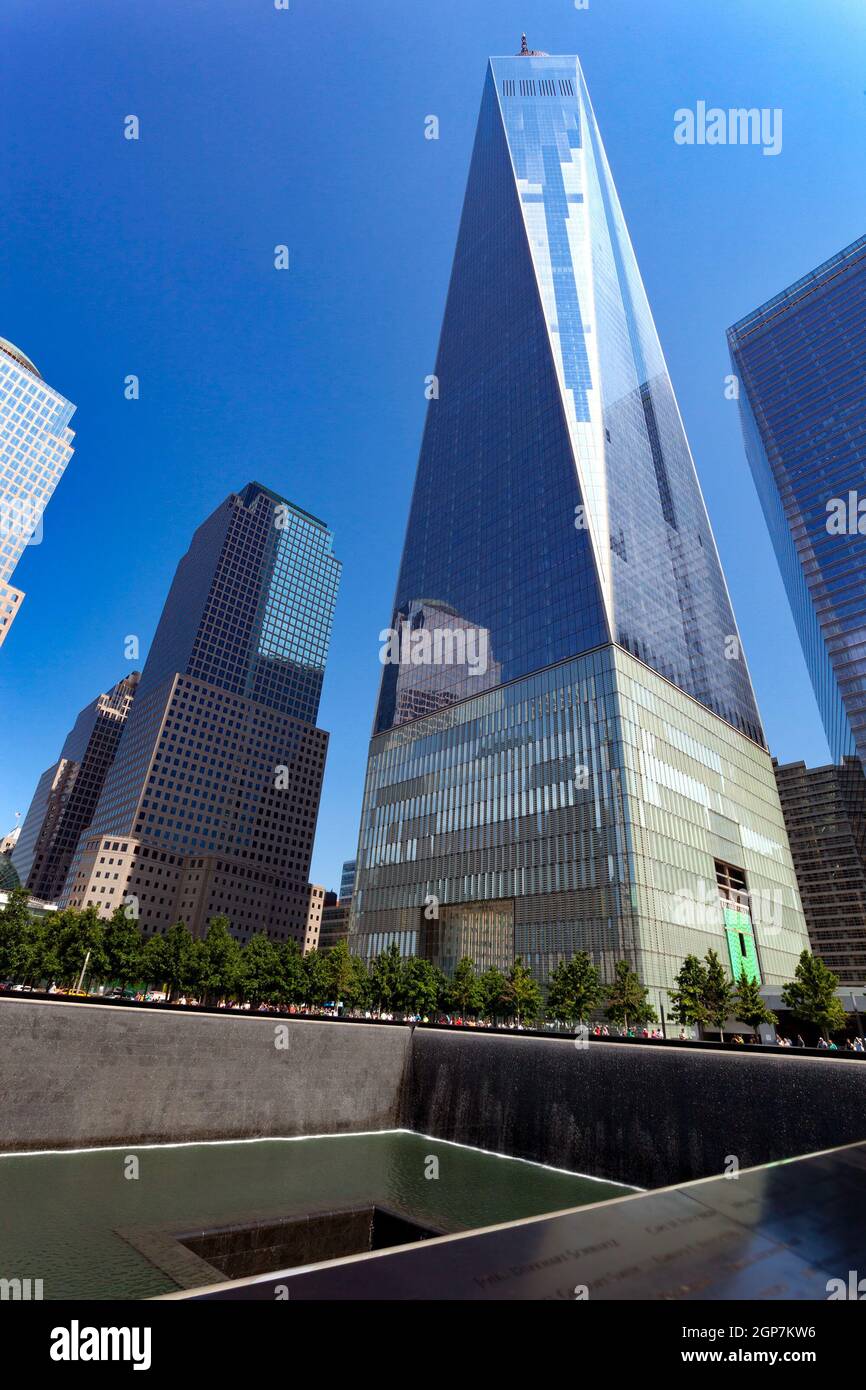 NEW YORK, NY - JULY 11, 2015: Freedom Tower and Memorial Fountain commemorating the September 11 ...