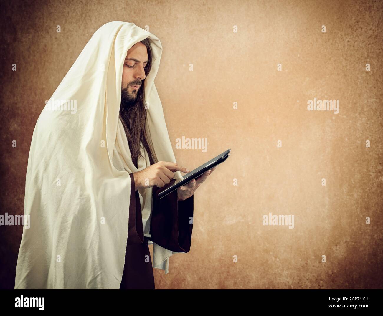 Jesus Christ reads the Holy Bible with the tablet Stock Photo - Alamy