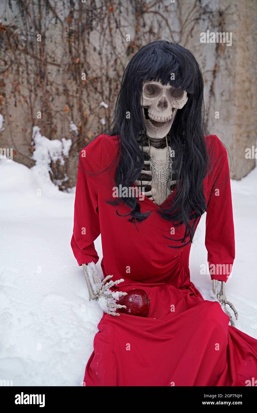 Last apple skeleton with red dress and red apple Stock Photo - Alamy