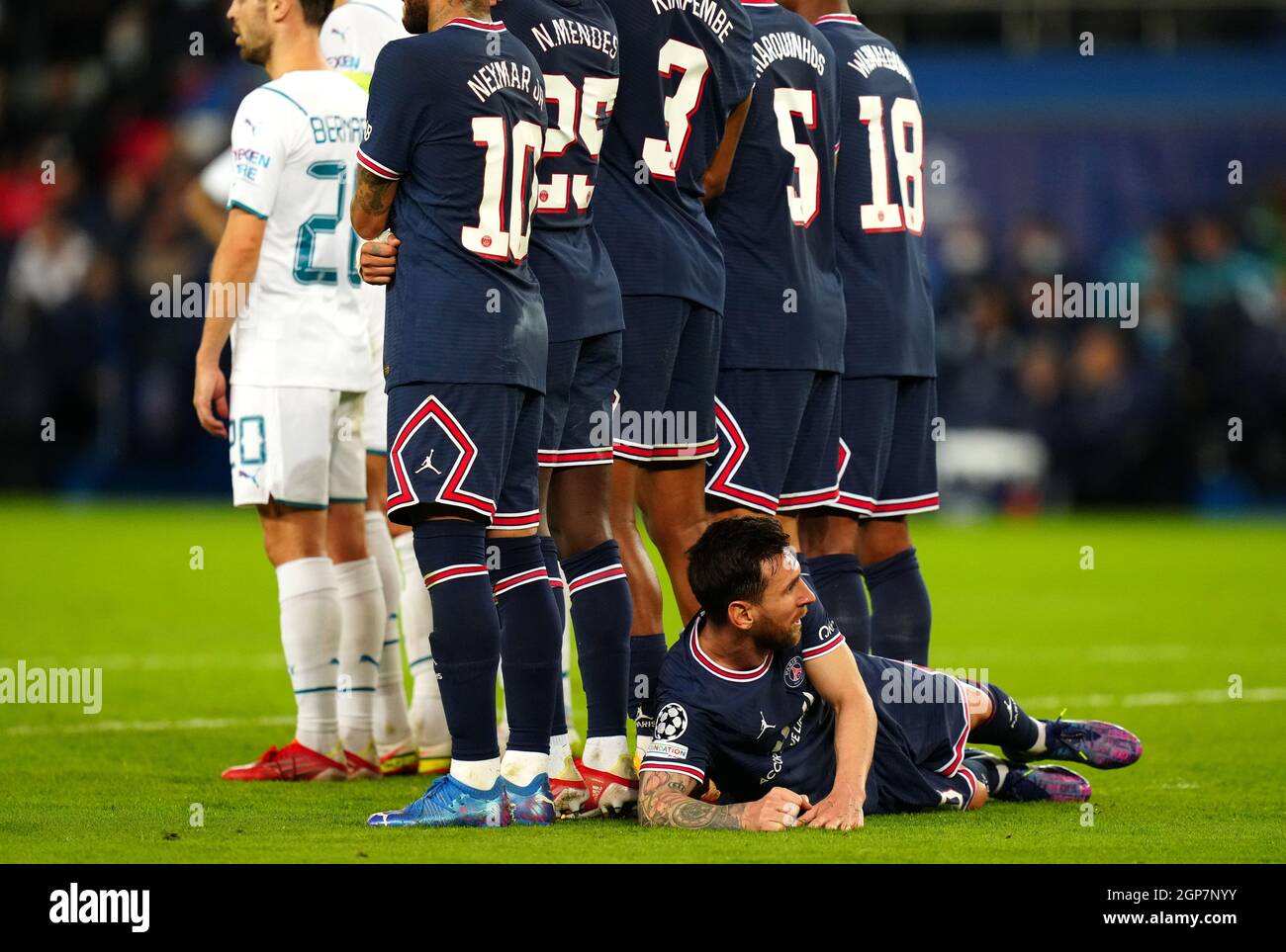 Paris Saint-Germain's Lionel Messi lies down behind the wall during the ...