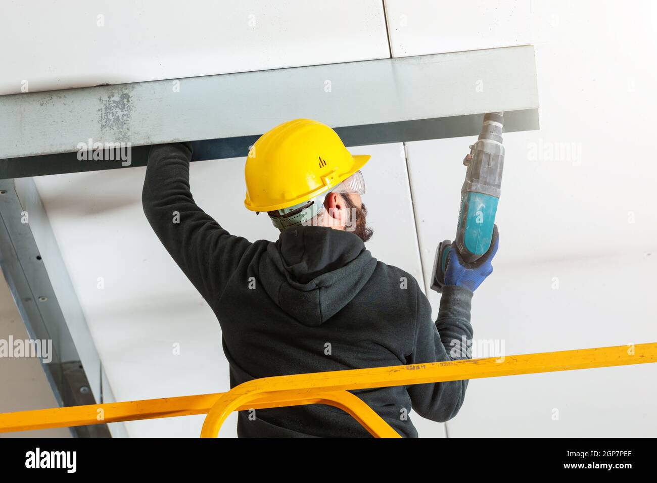 Worker at work in the construction of a plasterboard wall Stock Photo ...