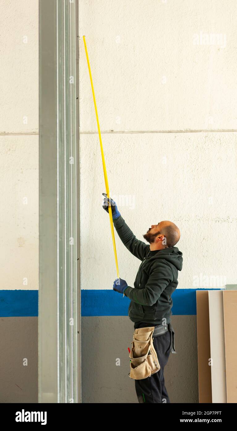 Worker at work in the construction of a plasterboard wall Stock Photo ...