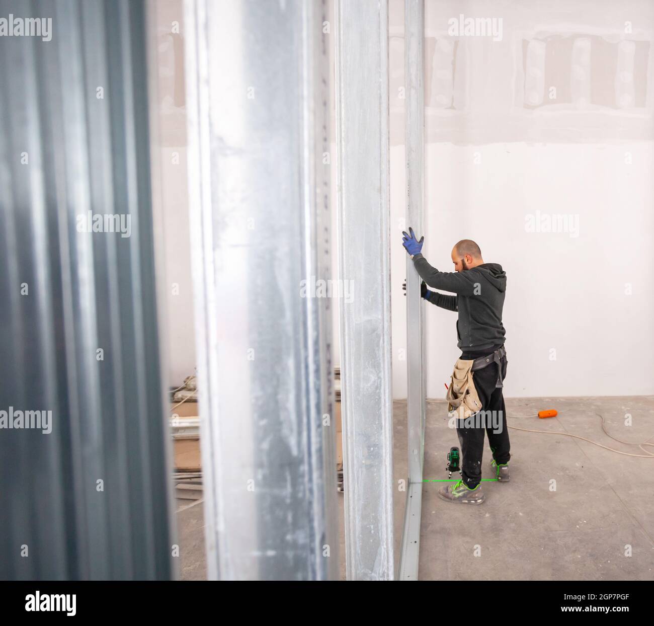 Worker at work in the construction of a plasterboard wall Stock Photo ...