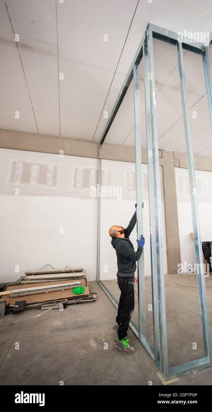 Worker at work in the construction of a plasterboard wall Stock Photo ...