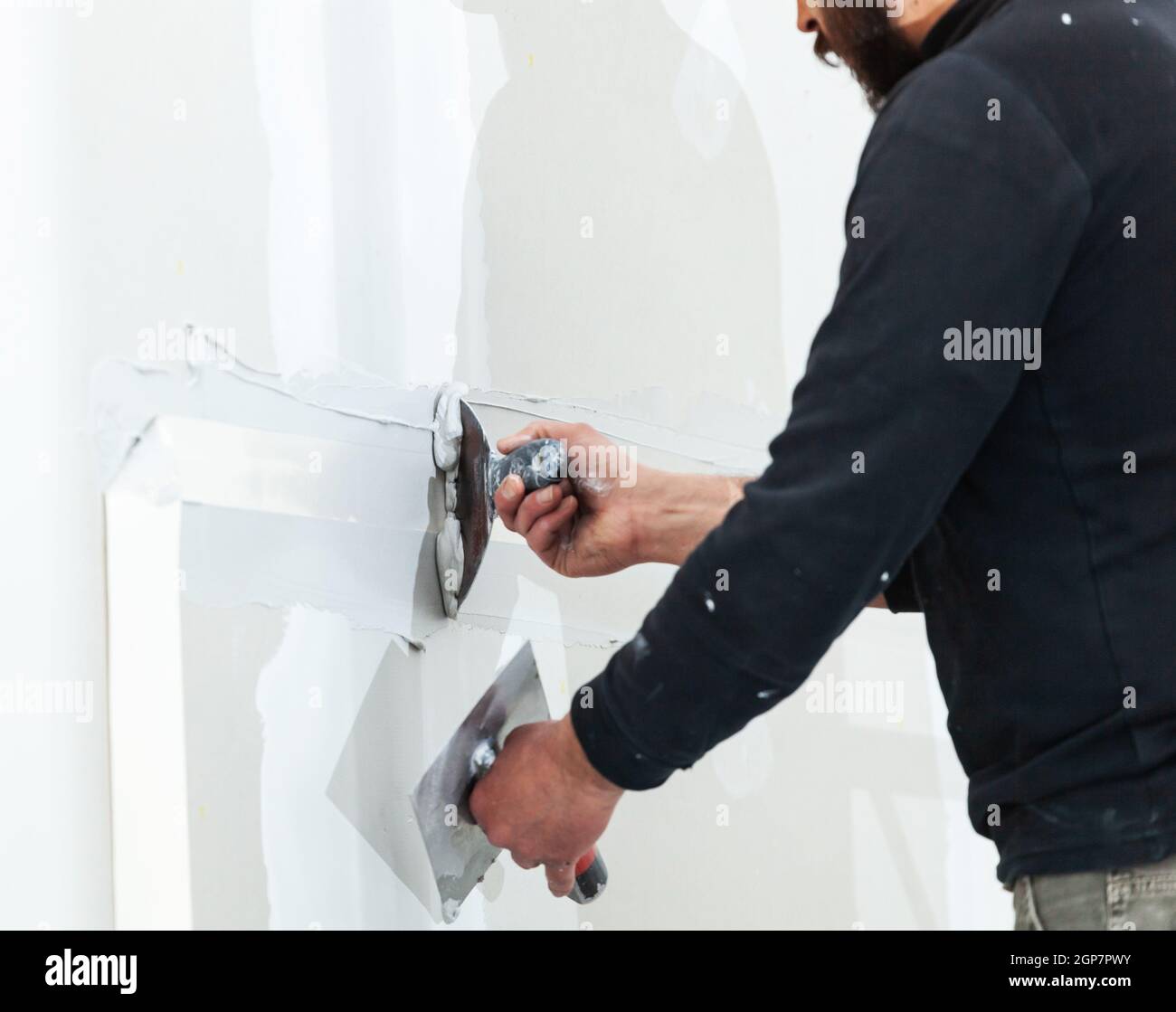 Interior construction, worker plastering gypsum board wall Stock Photo ...