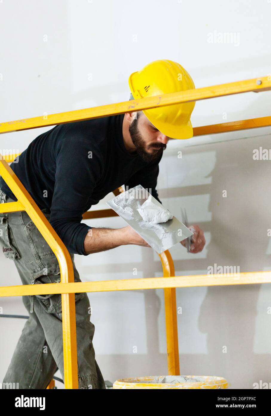 Interior construction, worker plastering gypsum board wall Stock Photo ...